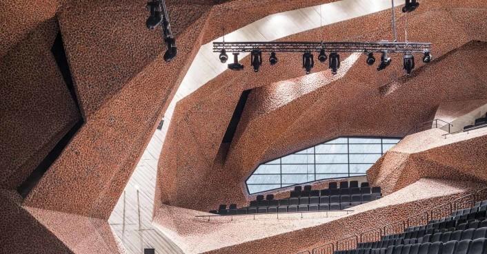 Crushed bricks recycled for a cave-like concert hall in Poland
